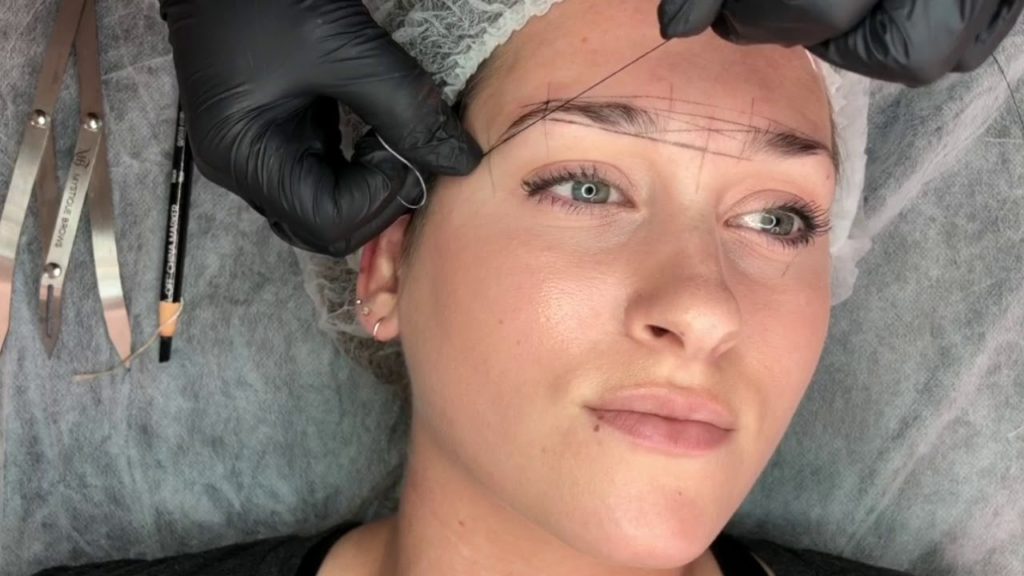 Plucking eyebrows with thread and thread technique