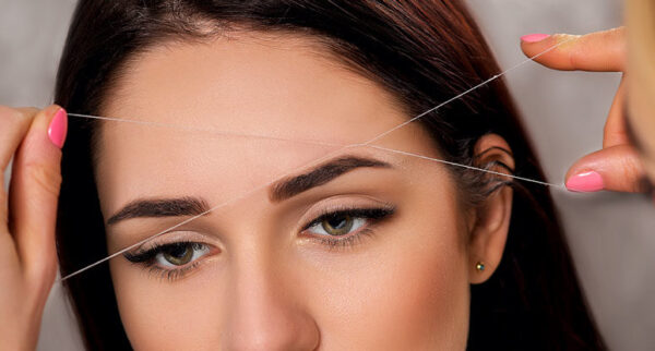Plucking eyebrows with thread and thread technique