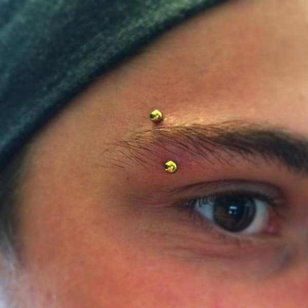 Eyebrow piercing yellow